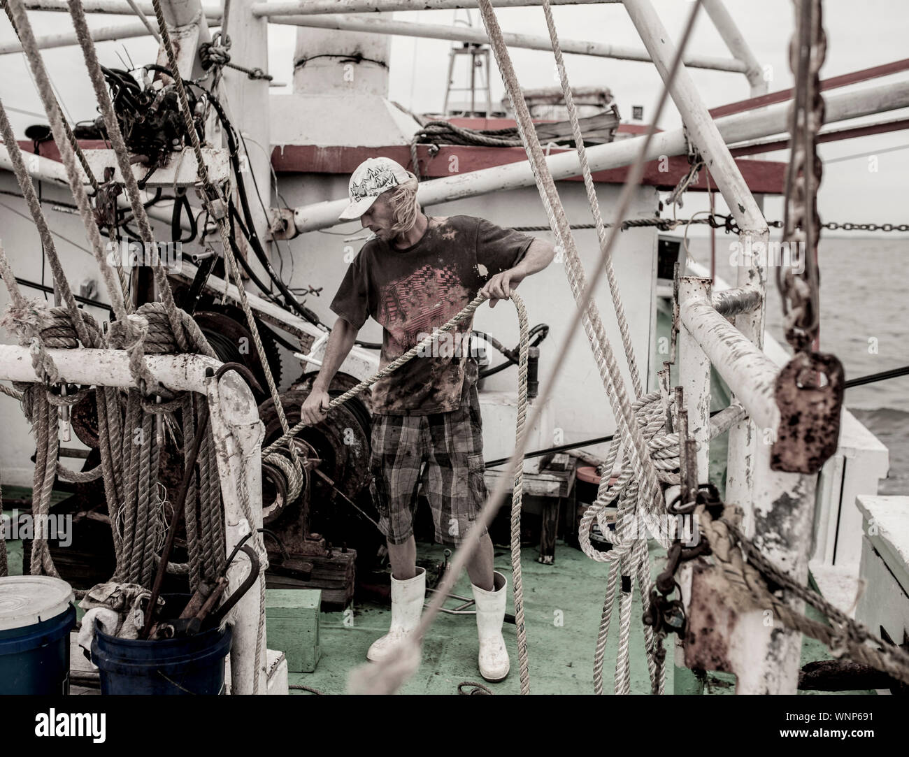 Commercial fisherman working on the deck of a ship Stock Photo - Alamy