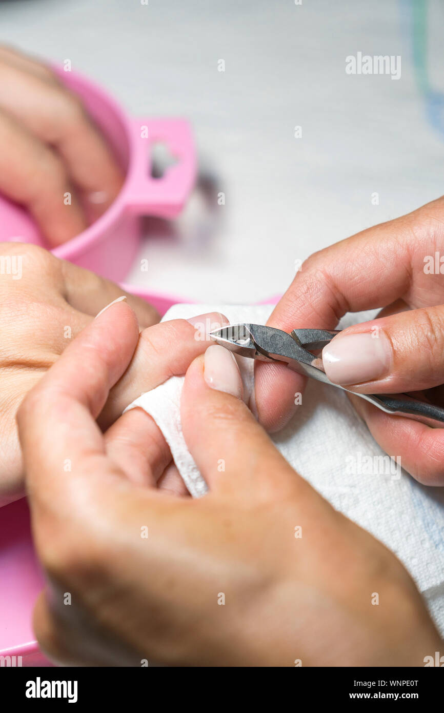 Close up woman hand while process of manicure in nail shop. Beautiful ...