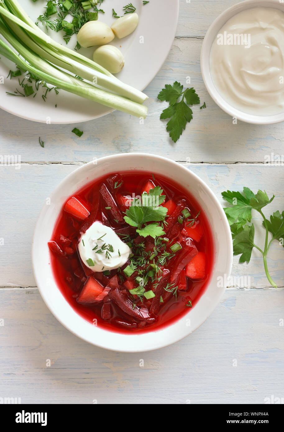 Beetroot soup in bowl on white wooden background. Traditional ukrainian ...
