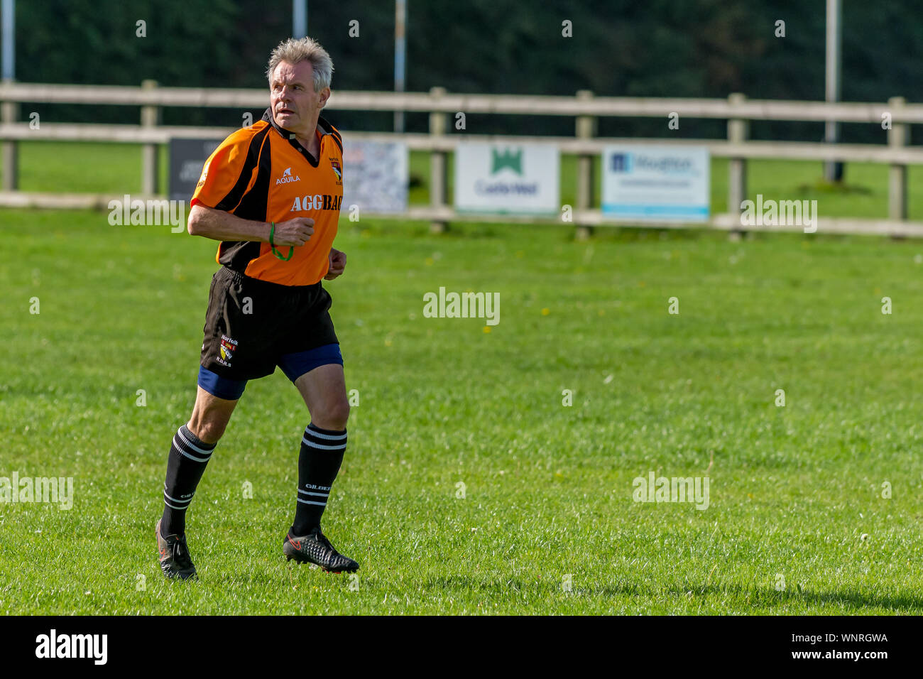 Senior (age 60-70) referee from Norfolk Referee Society jogs across the ...