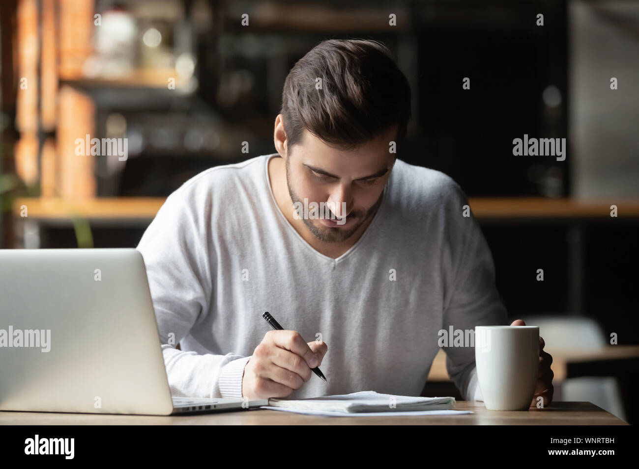Focused worker writing in notebook hi-res stock photography and images ...