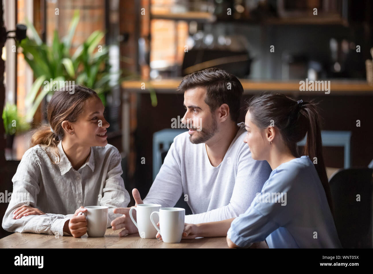 Group friends chatting in cafe hi-res stock photography and images - Alamy