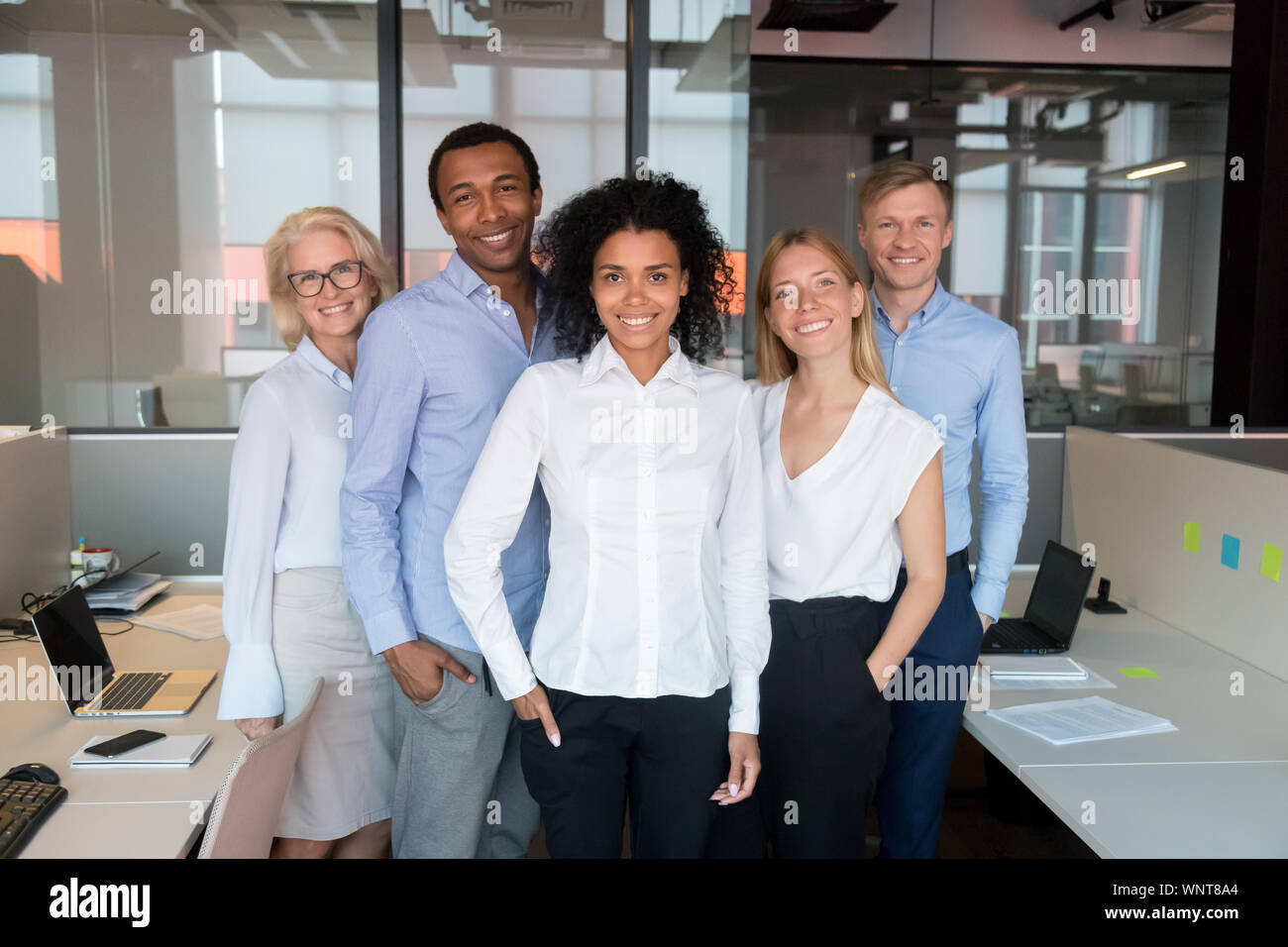 Portrait of smiling diverse employee look at camera making picture ...