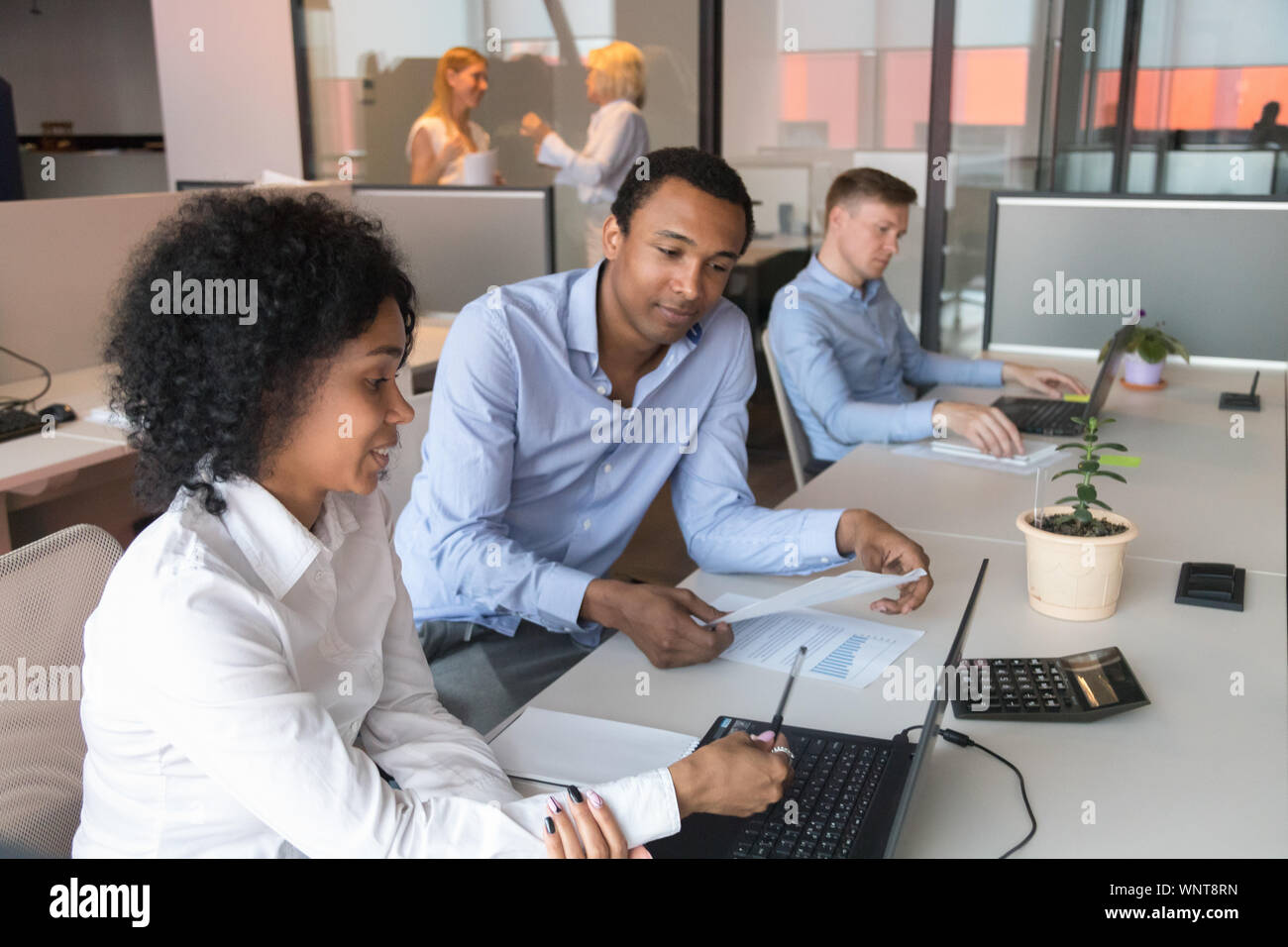 Black male supervisor analyze female trainee work at workplace Stock ...