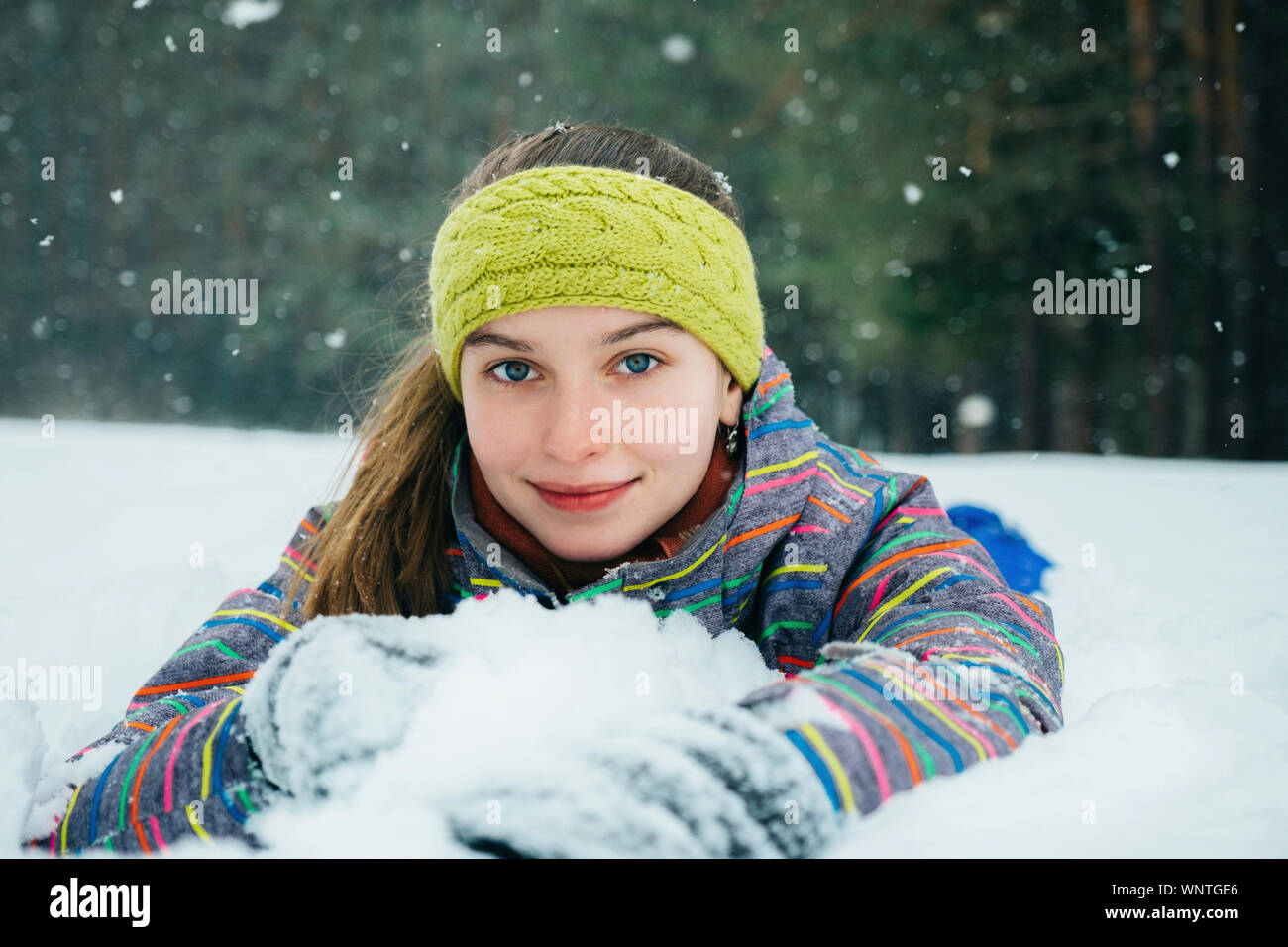 the girl lies in the snow and smiles Stock Photo - Alamy