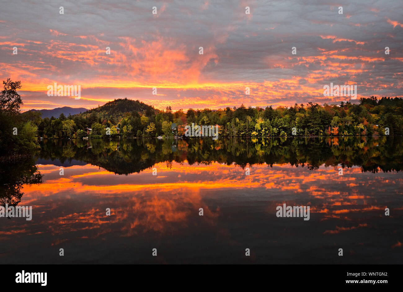 Colorful sunrise over calm and serene waters of ponds in Vermont and ...