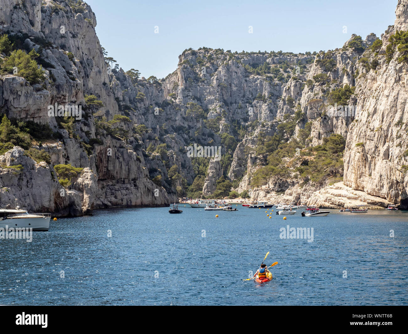 Kayaks, boats, and swimmers enjoy the beautiful blue waters of the ...