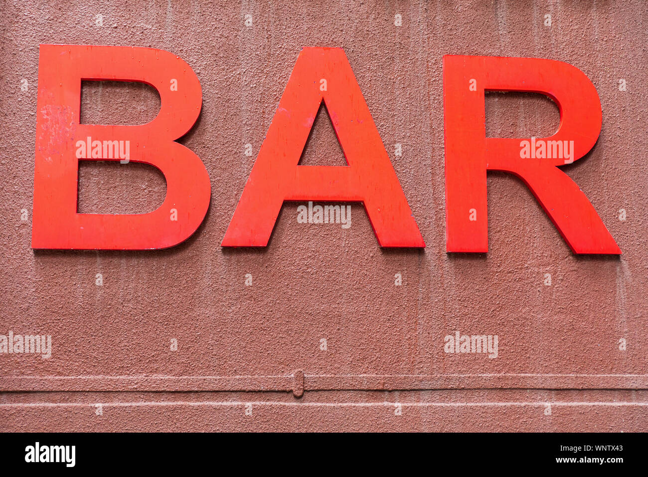 Big Red Bar Sing Letters at Wall Stock Photo - Alamy
