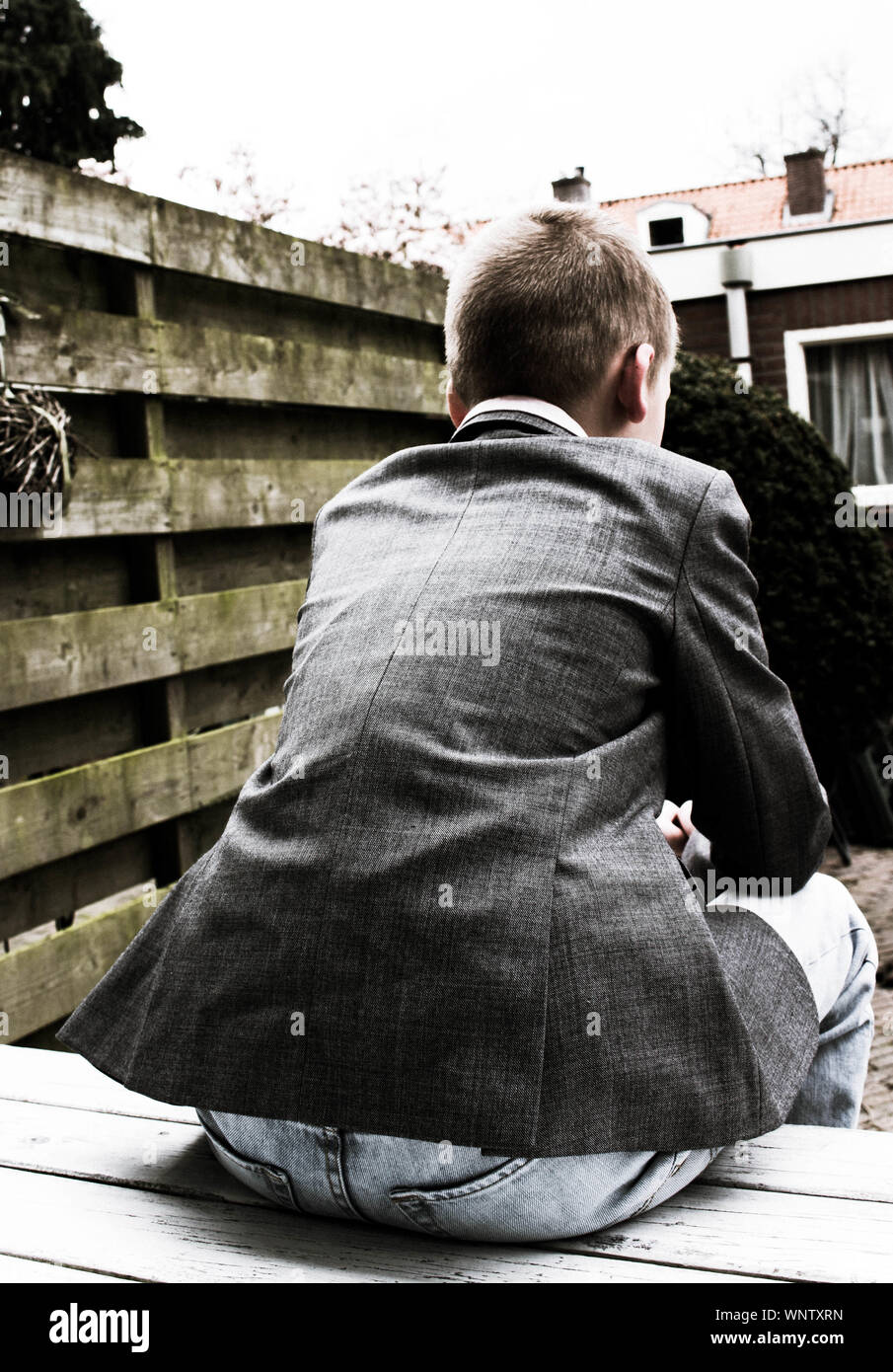 Boy sitting on bench rear view hi-res stock photography and images - Alamy Boy sitting on bench rear view hi-res stock photography and images - Alamy