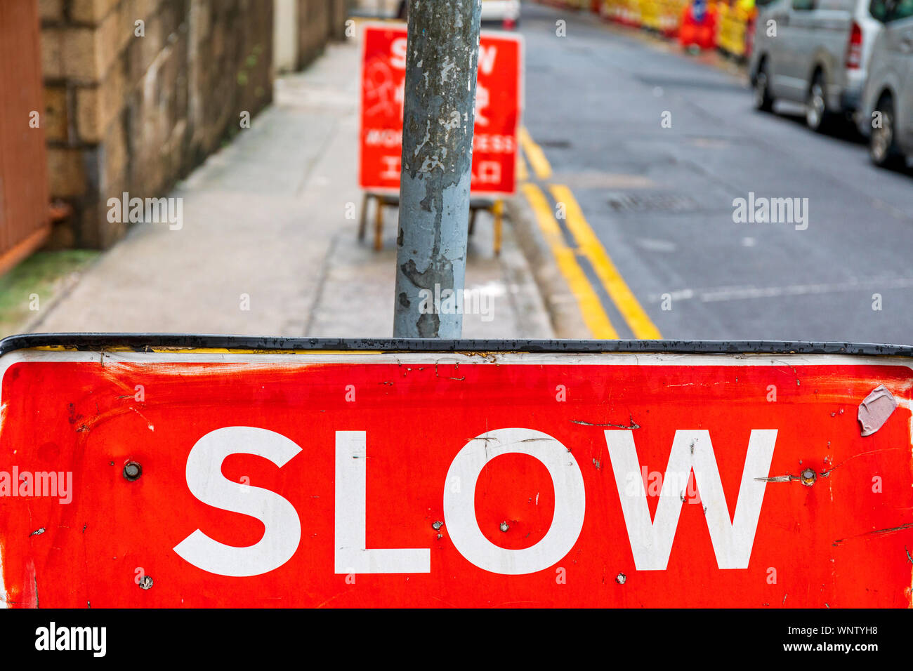 Big Red Slow Traffic Sign Warning in City Stock Photo - Alamy