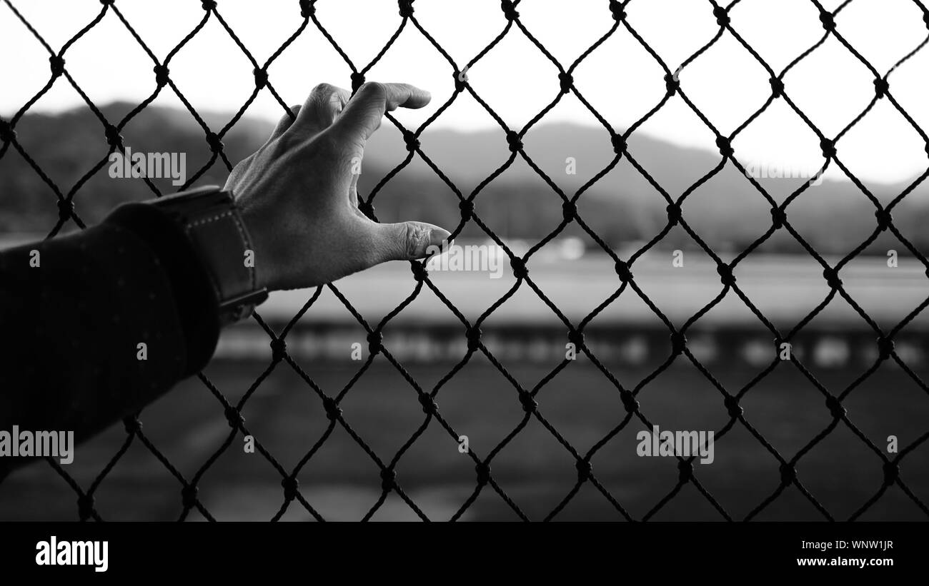 Hand fence chainlink fence hi-res stock photography and images - Alamy