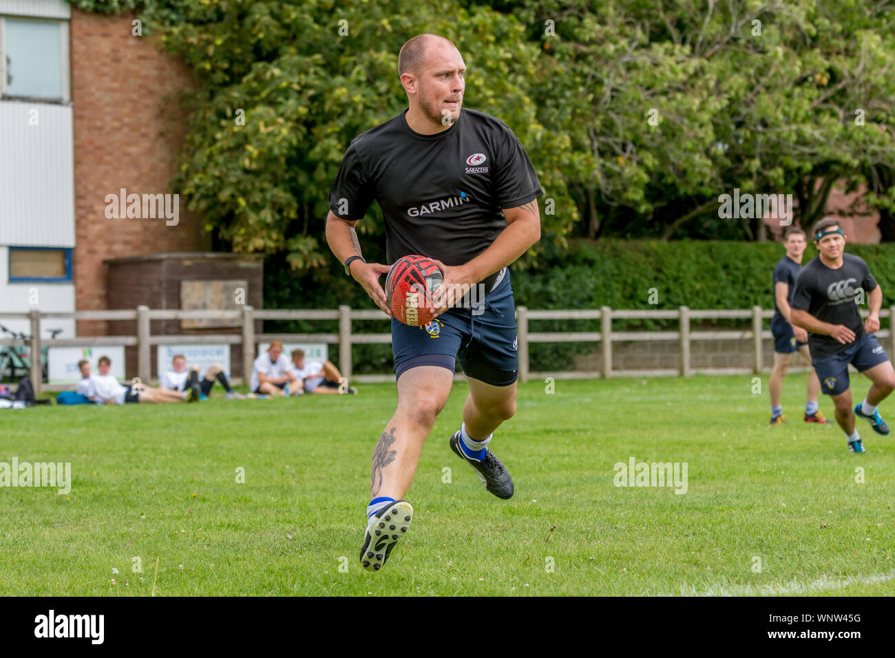 Amateur touch rugby player (male, 20-30 y) running with rugby ball in ...