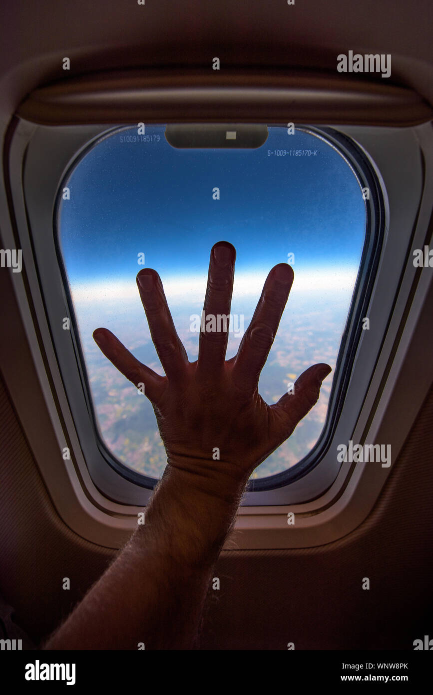 Human hand on airplane window hi-res stock photography and images - Alamy