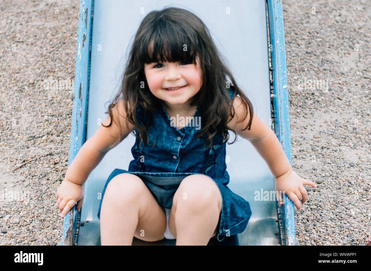 Girl playing slide hi-res stock photography and images - Alamy