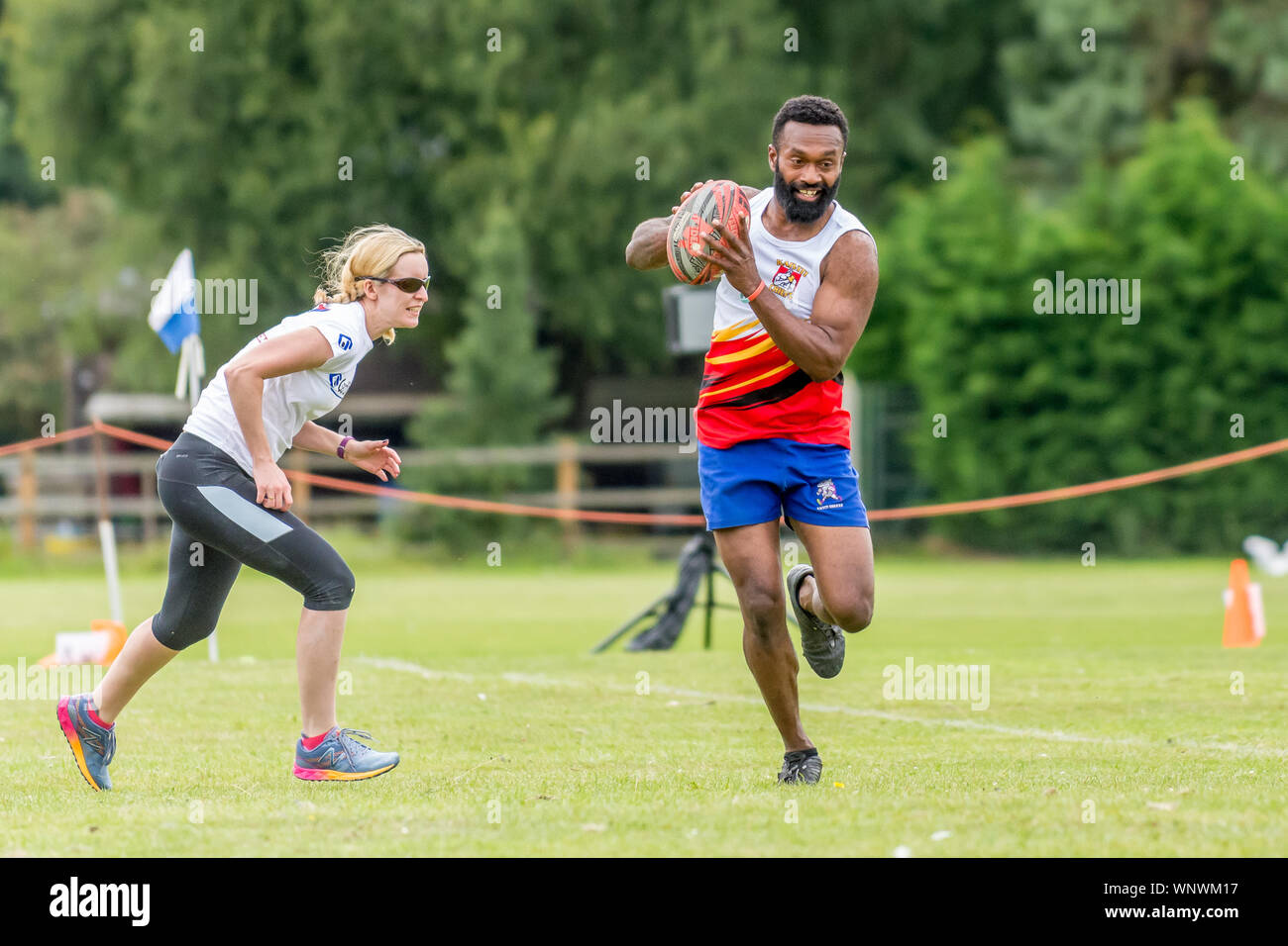 Amateur touch rugby player (Fijian male, 40-50 y) evades touch tackle ...