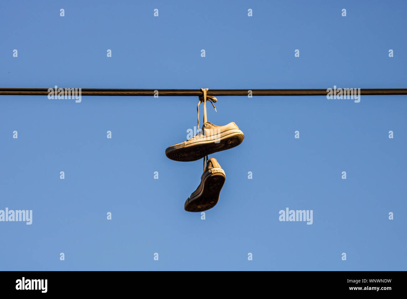 Shoes hanging from a wire in Bucharest Stock Photo - Alamy