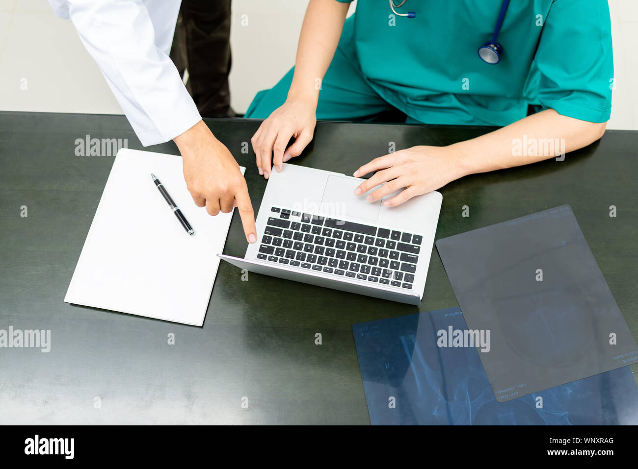 Teamwork of professional doctor men medical team consulting with laptop computer in hospital ...
