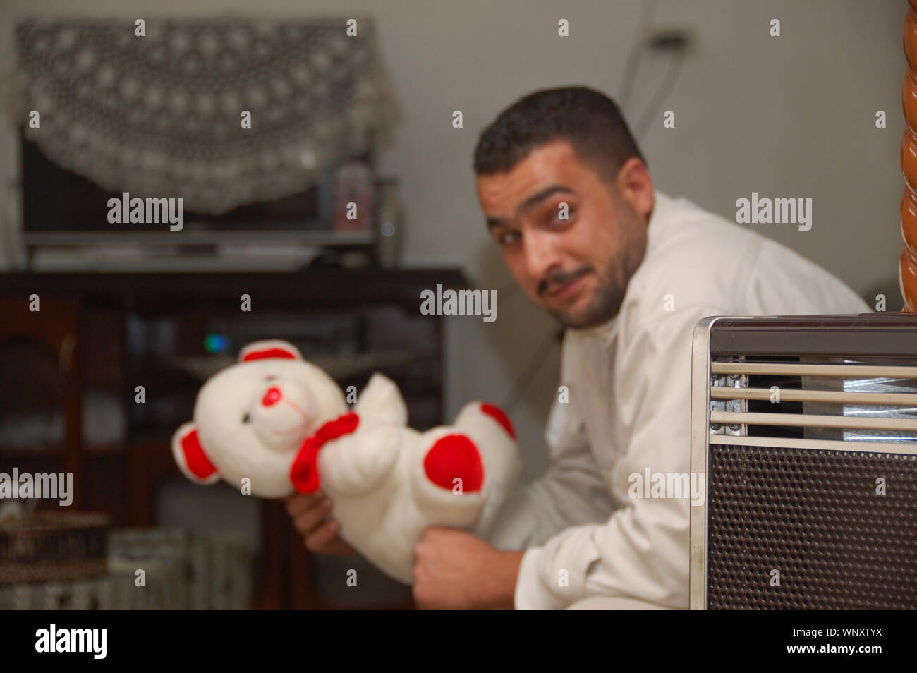 Syrian man with teddy bear Stock Photo - Alamy