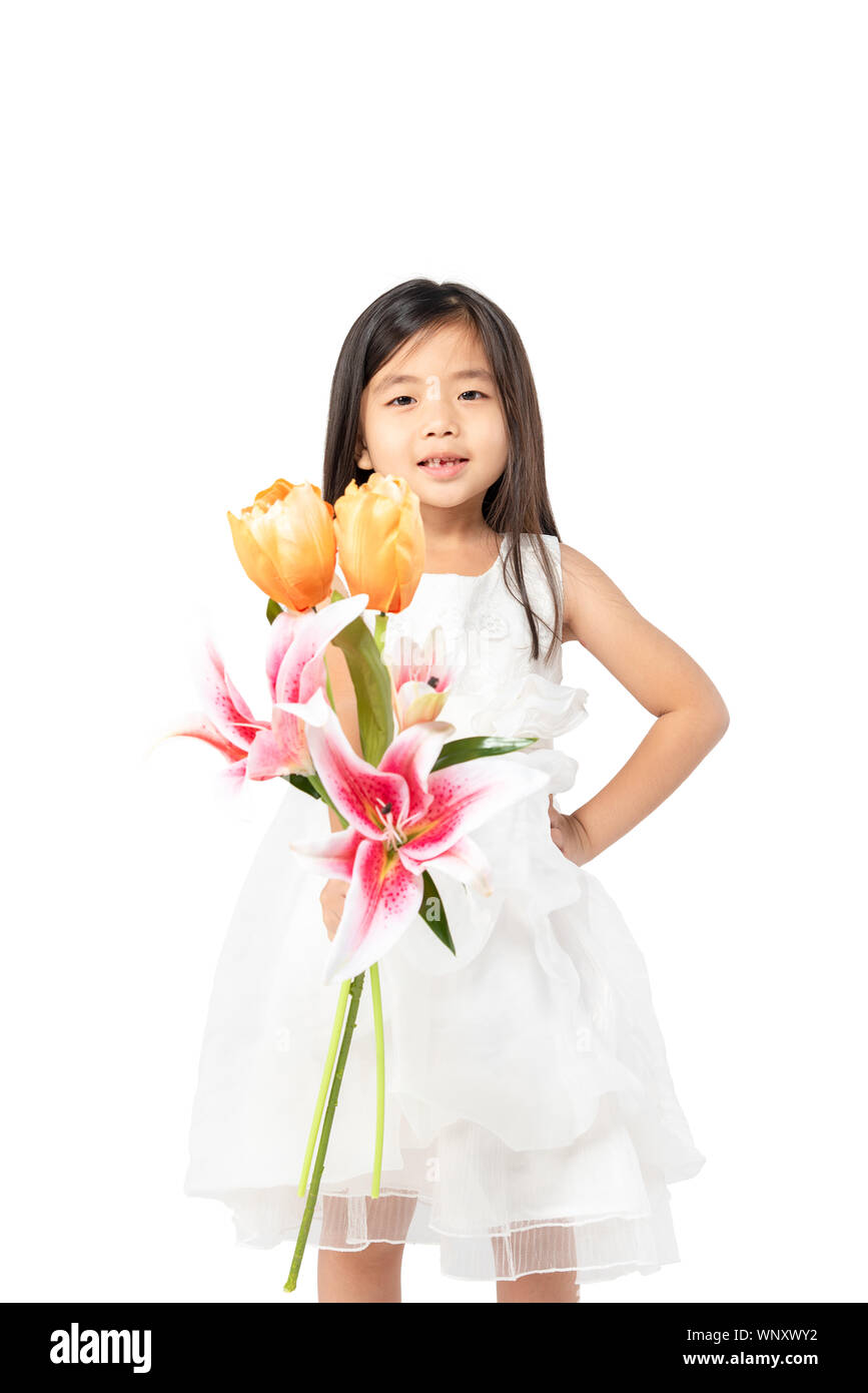 Portrait of so cute thoughtful asian child girl with flower in hands ...