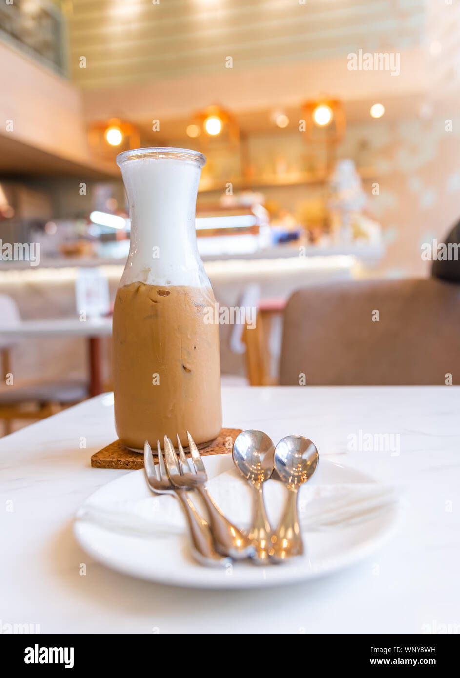 Iced coffee in glass is on the table at modern cafe and restaurant in ...