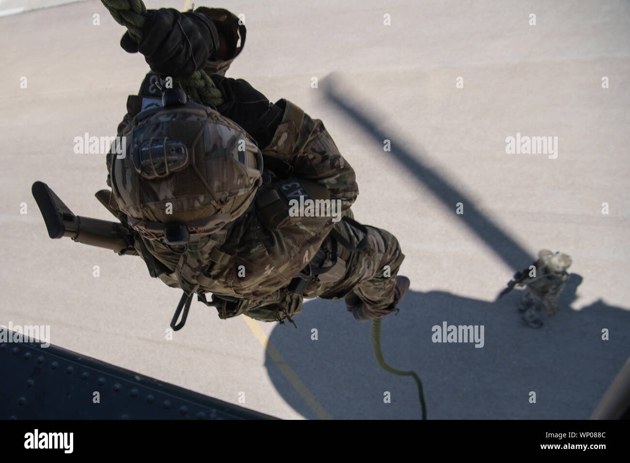 A Cypriot National Guard Special Forces slides down a rope during fast ...