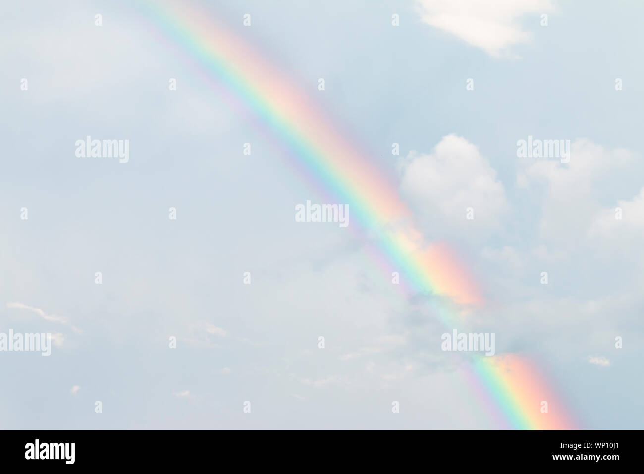 Rainbow, clouds and blue sky Stock Photo - Alamy