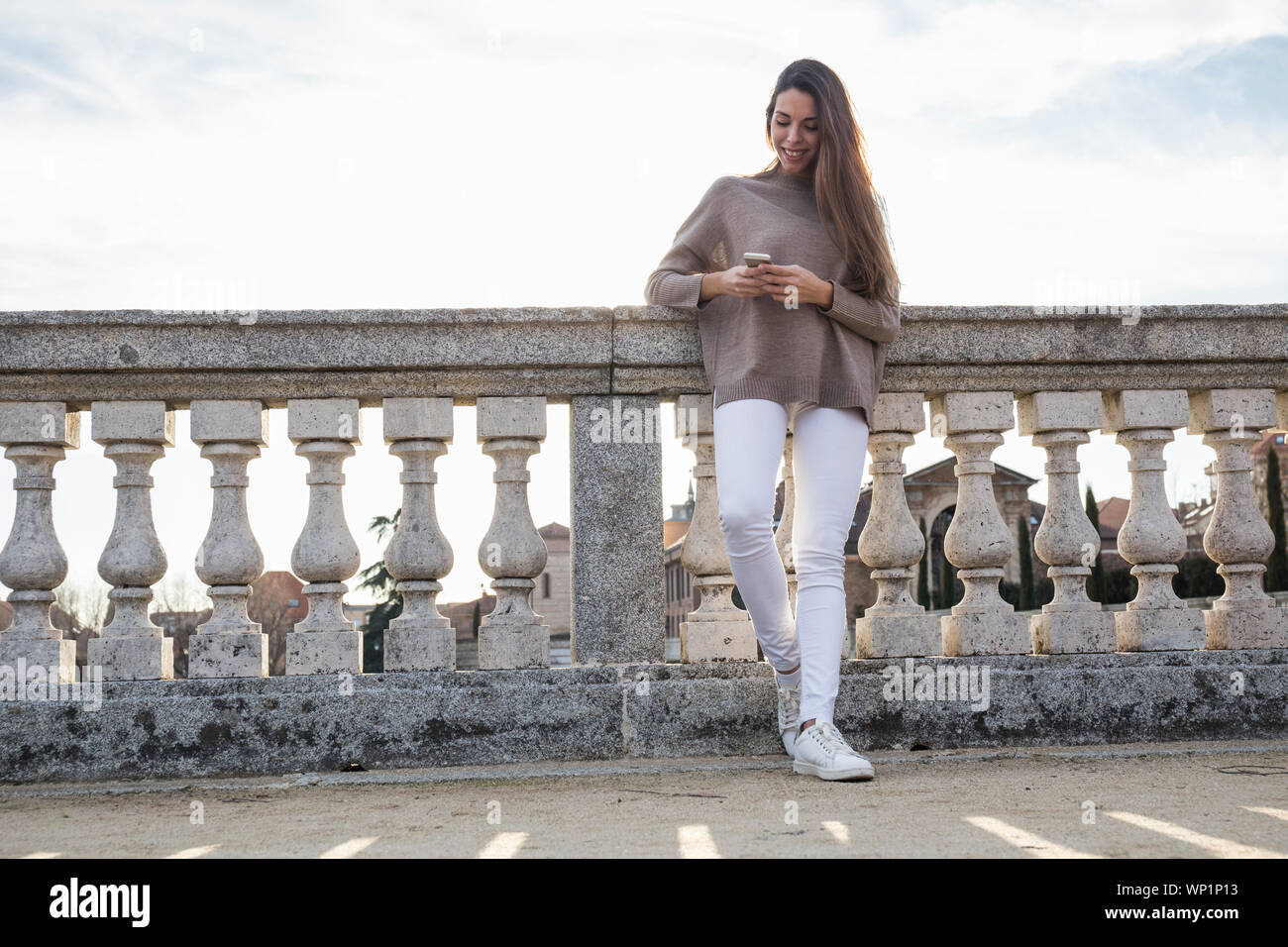 Woman leaning against railing using hi-res stock photography and images ...