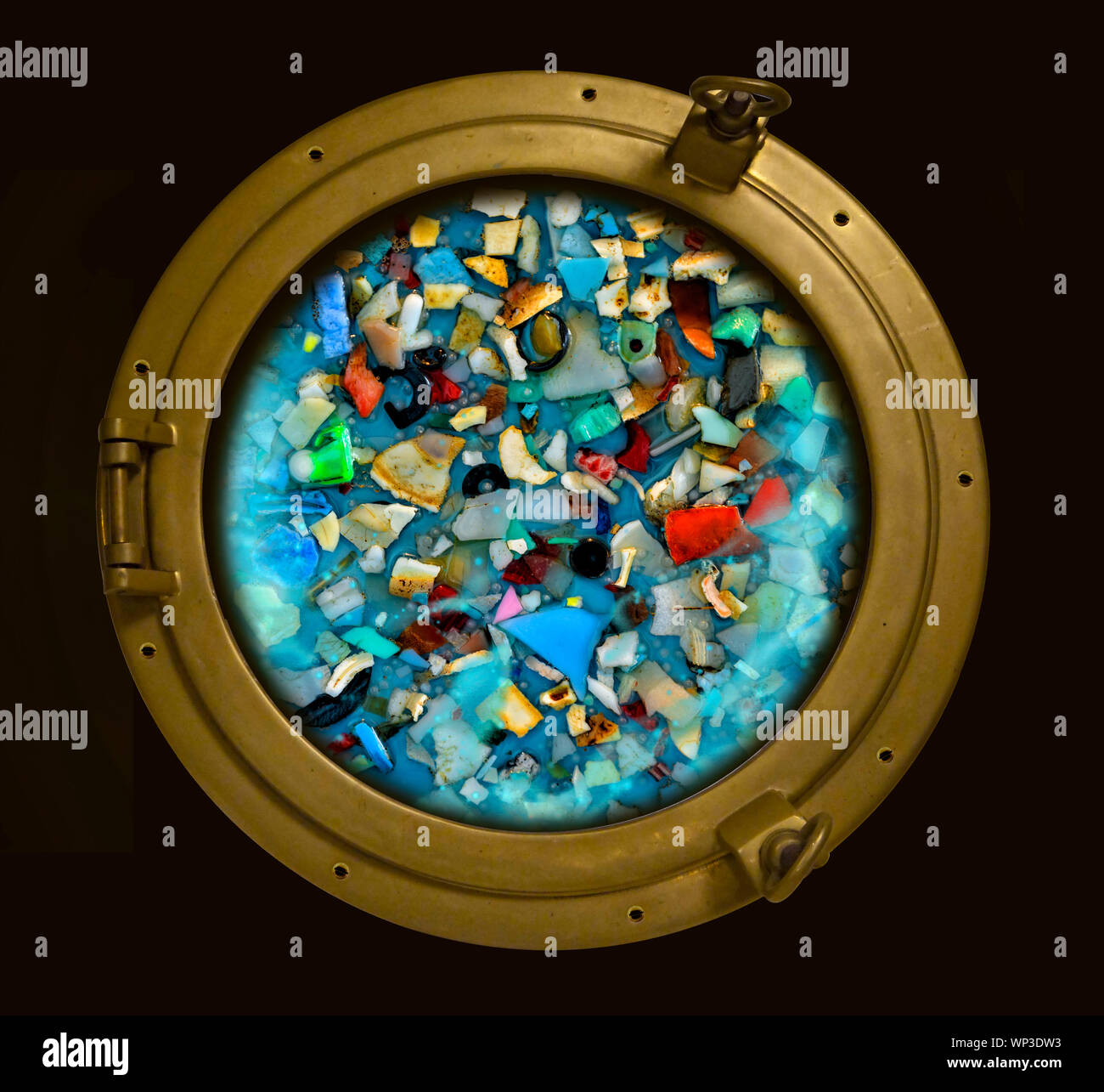 Plastic particles waste in the ocean., seen through a porthole window ...