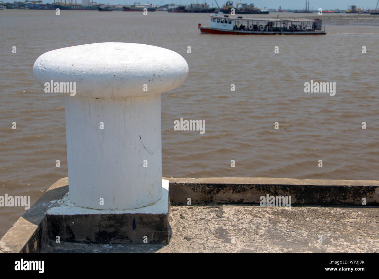 A shore with a white bollard and ferry on background Stock Photo - Alamy