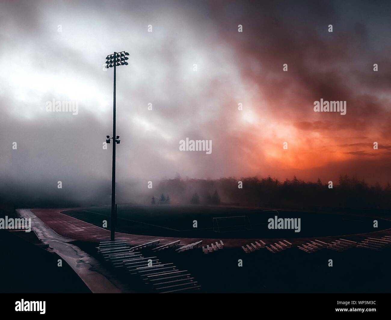 The green grass field of football field in the fog hi-res stock ...