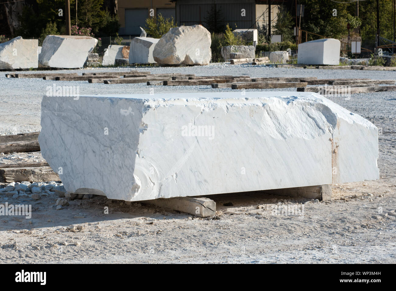 Large rectangular cut block of white Carrara marble in the forecourt of ...