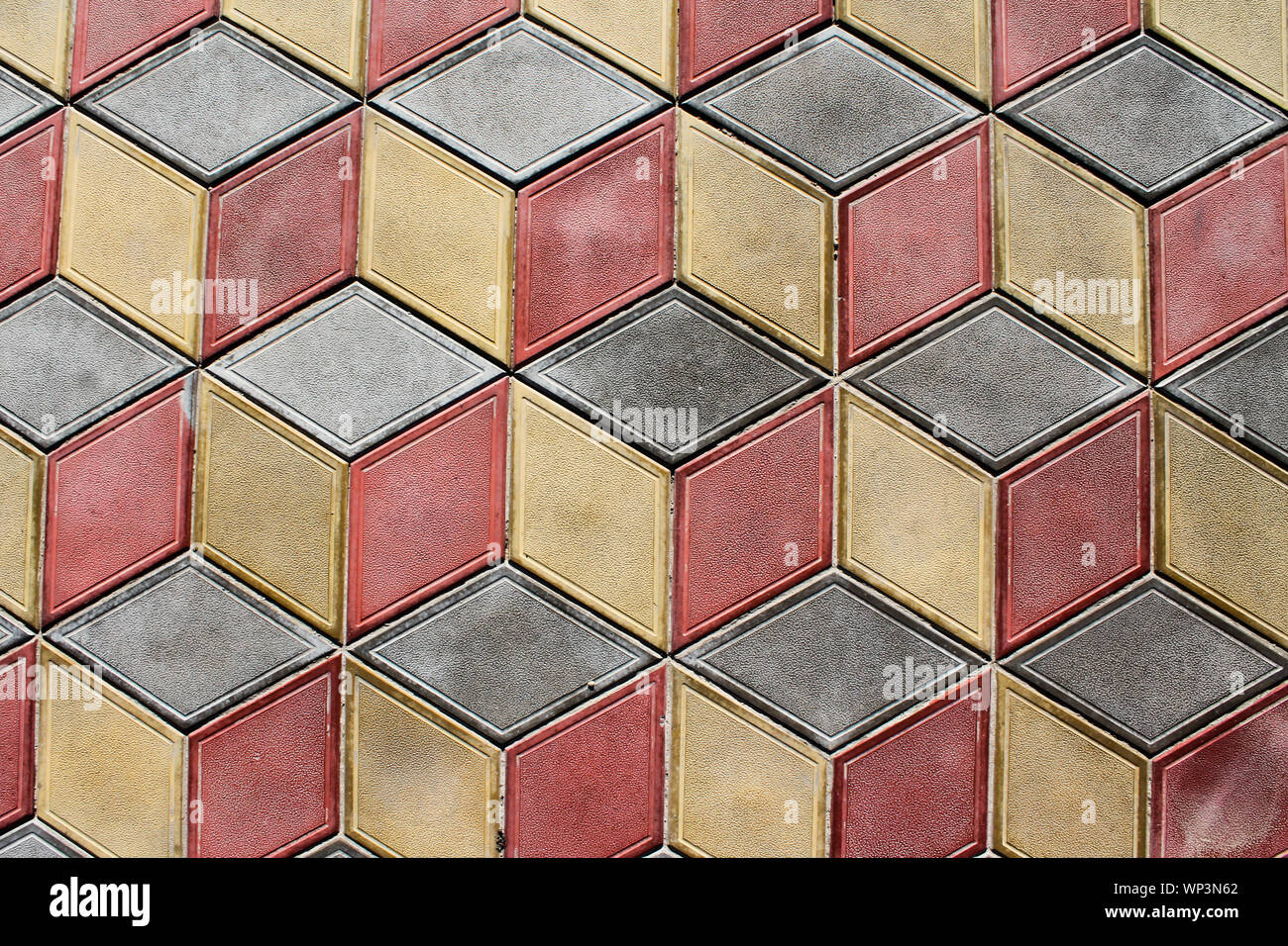 Colorful geometric tiles on the ground. Diamond shaped tiles of gray ...