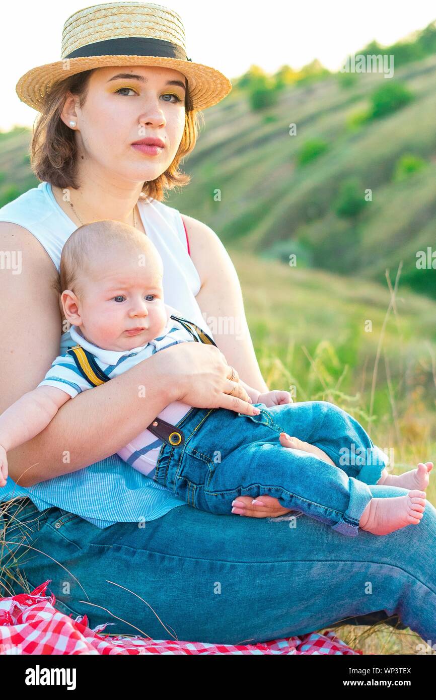 Mom with baby spending time together at sunset, on summer Stock Photo ...
