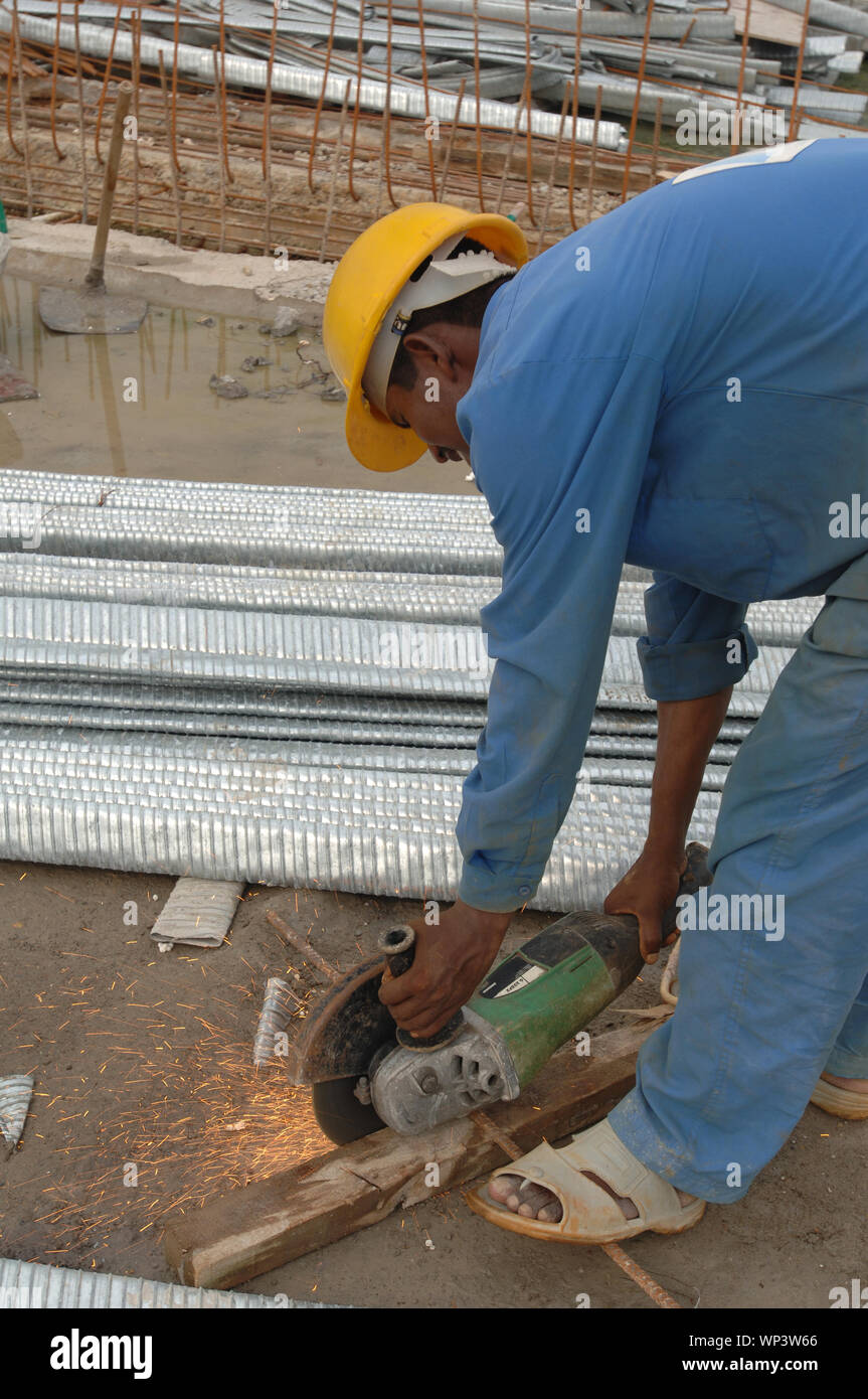 Manual worker working at construction site Stock Photo - Alamy