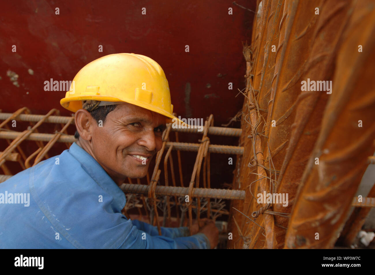 Manual worker working at construction site Stock Photo - Alamy