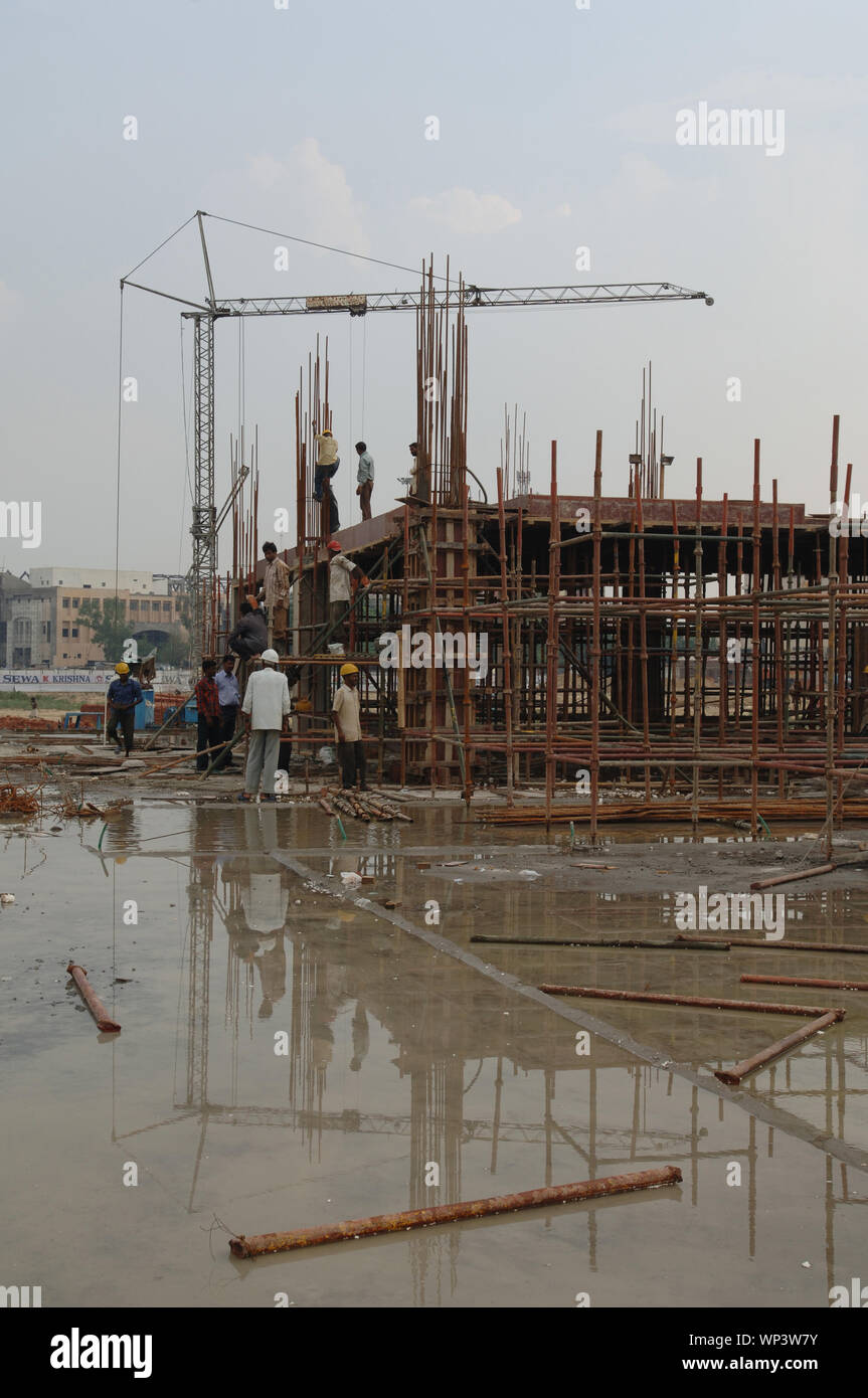 Manual worker working at construction site Stock Photo - Alamy