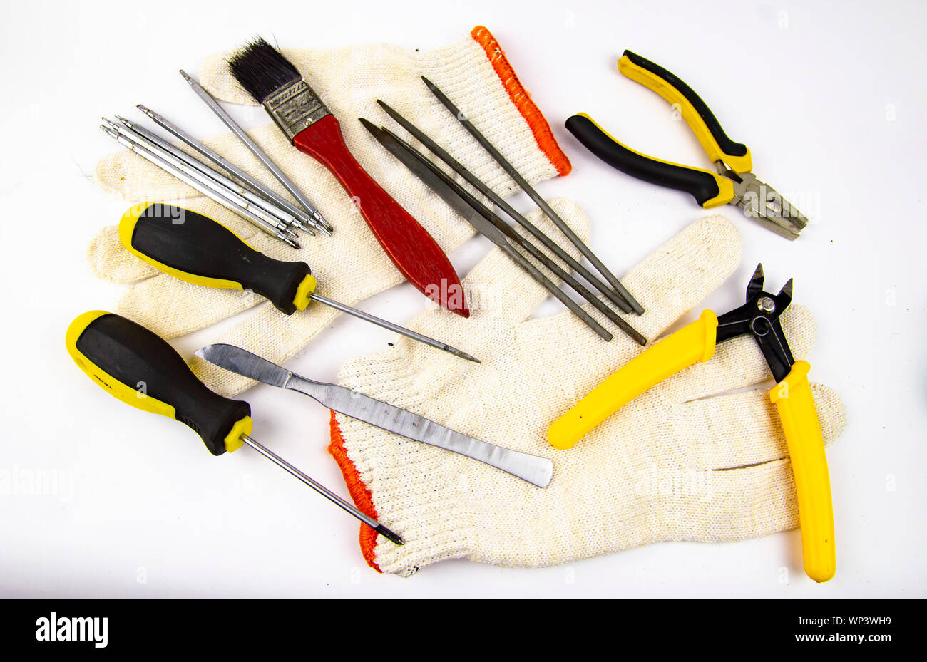 Work tool on white background - screwdriver, pliers, needle file ...
