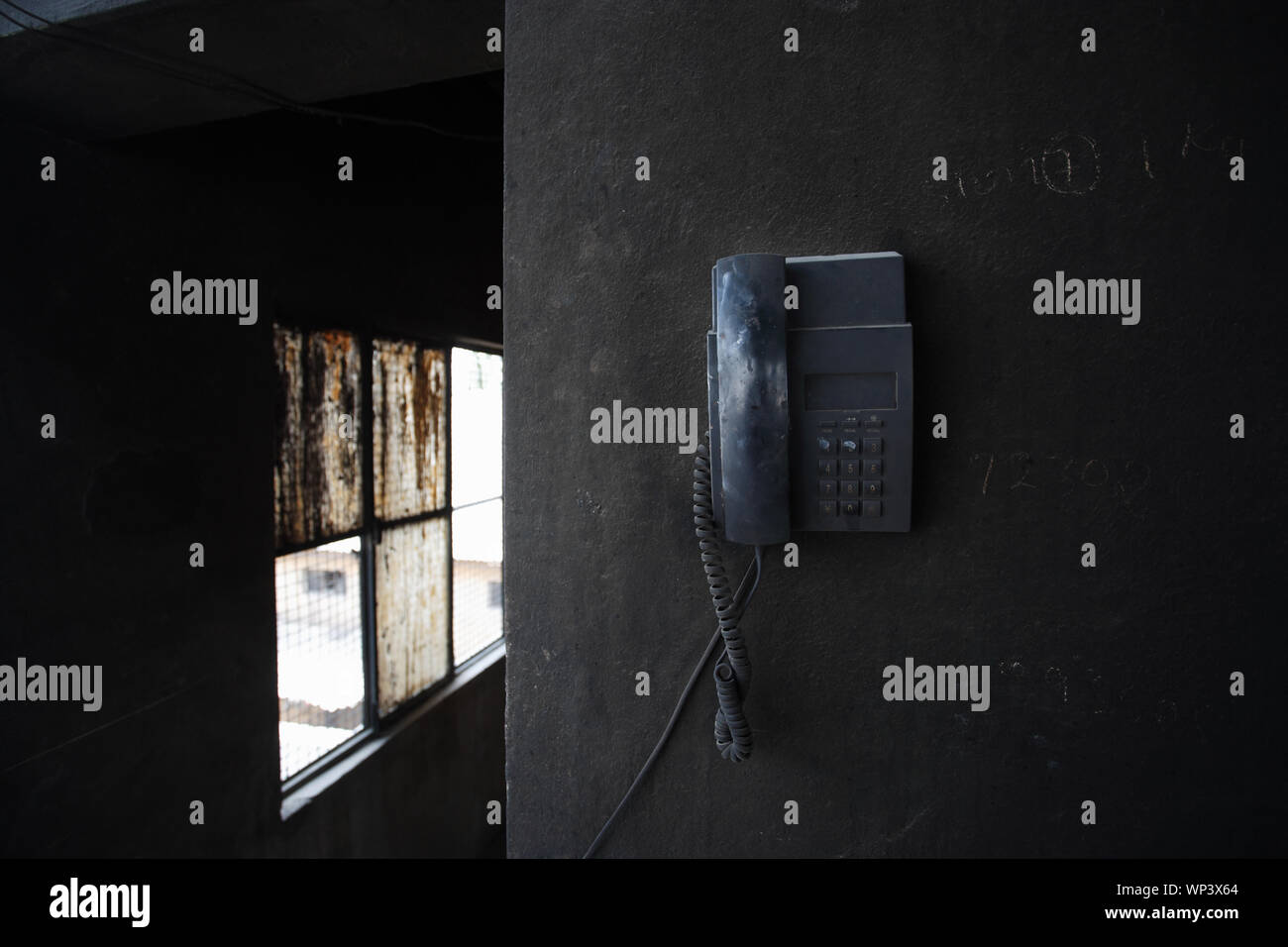 Landline phone mounted on wall Stock Photo - Alamy