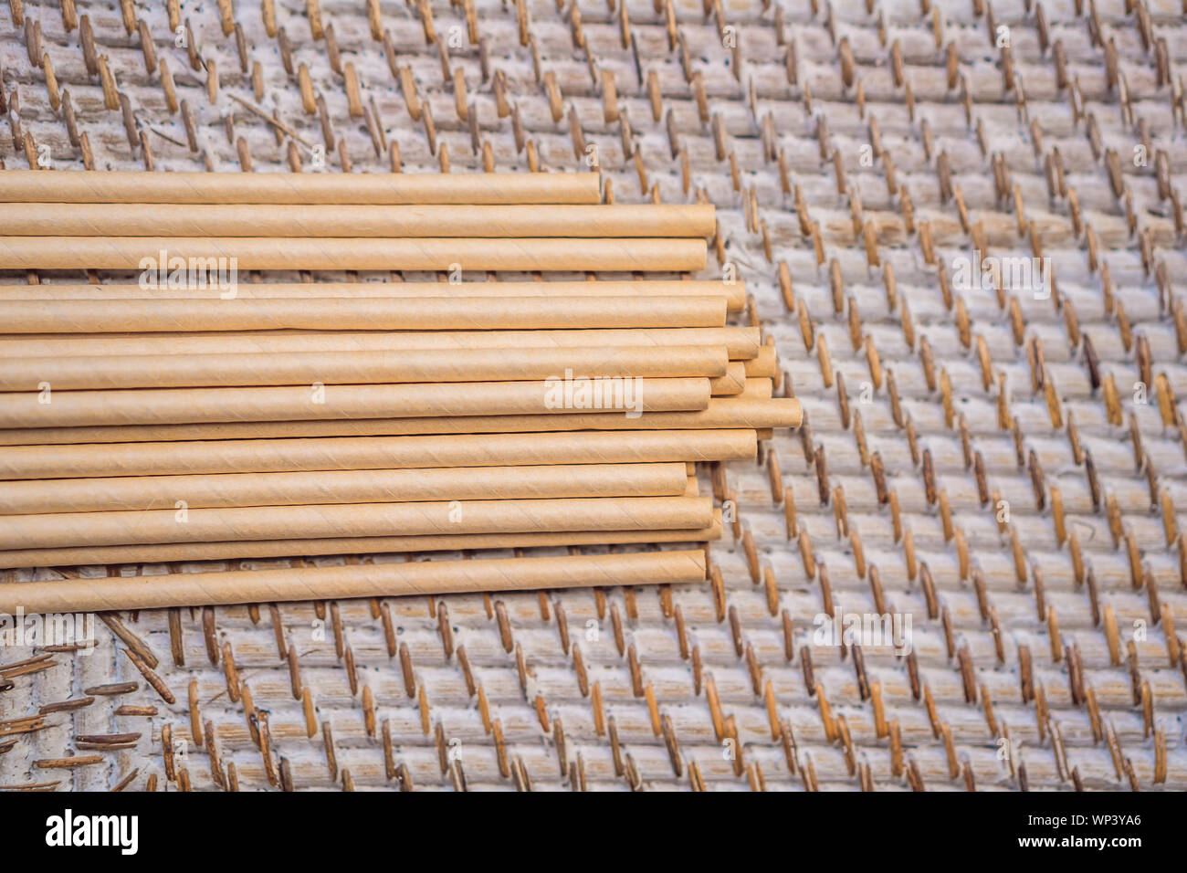Retro paper straws on a straw background Stock Photo - Alamy