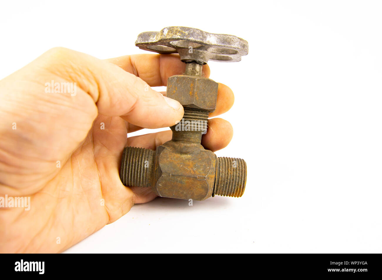 Old water valve in the hands of a man on a white background, space for ...