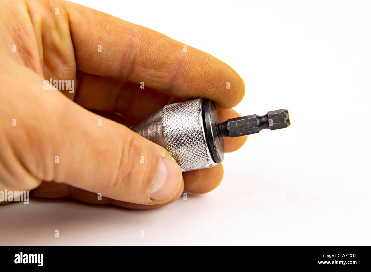 drill chuck in man's hand isolated on white background, space for text ...