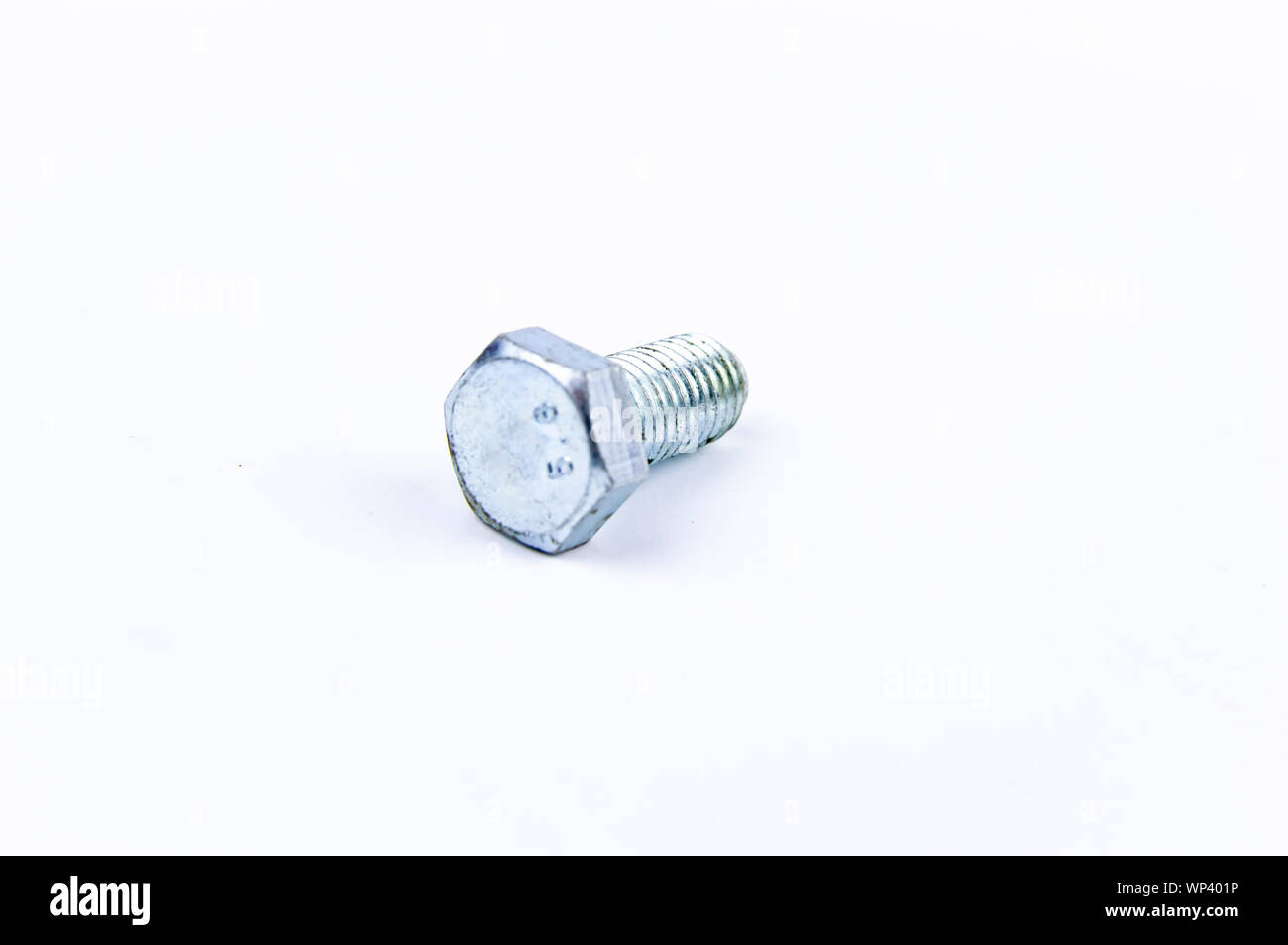 Metal bolt on a white background, place for text Stock Photo - Alamy