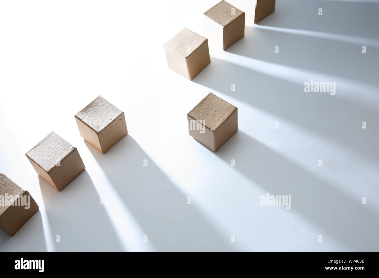One cardboard cube against cubes in a row Stock Photo - Alamy