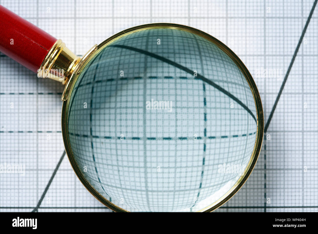 Closeup of magnifying glass on paper background with graph Stock Photo ...