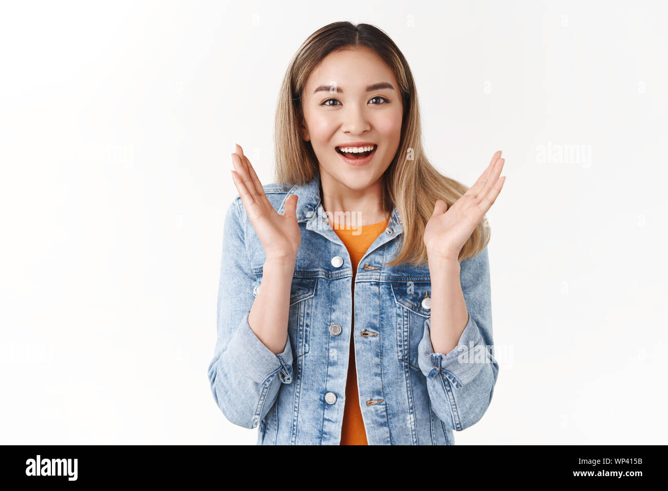 Entertained amused cute asian blond girl excited see incredible cool ...