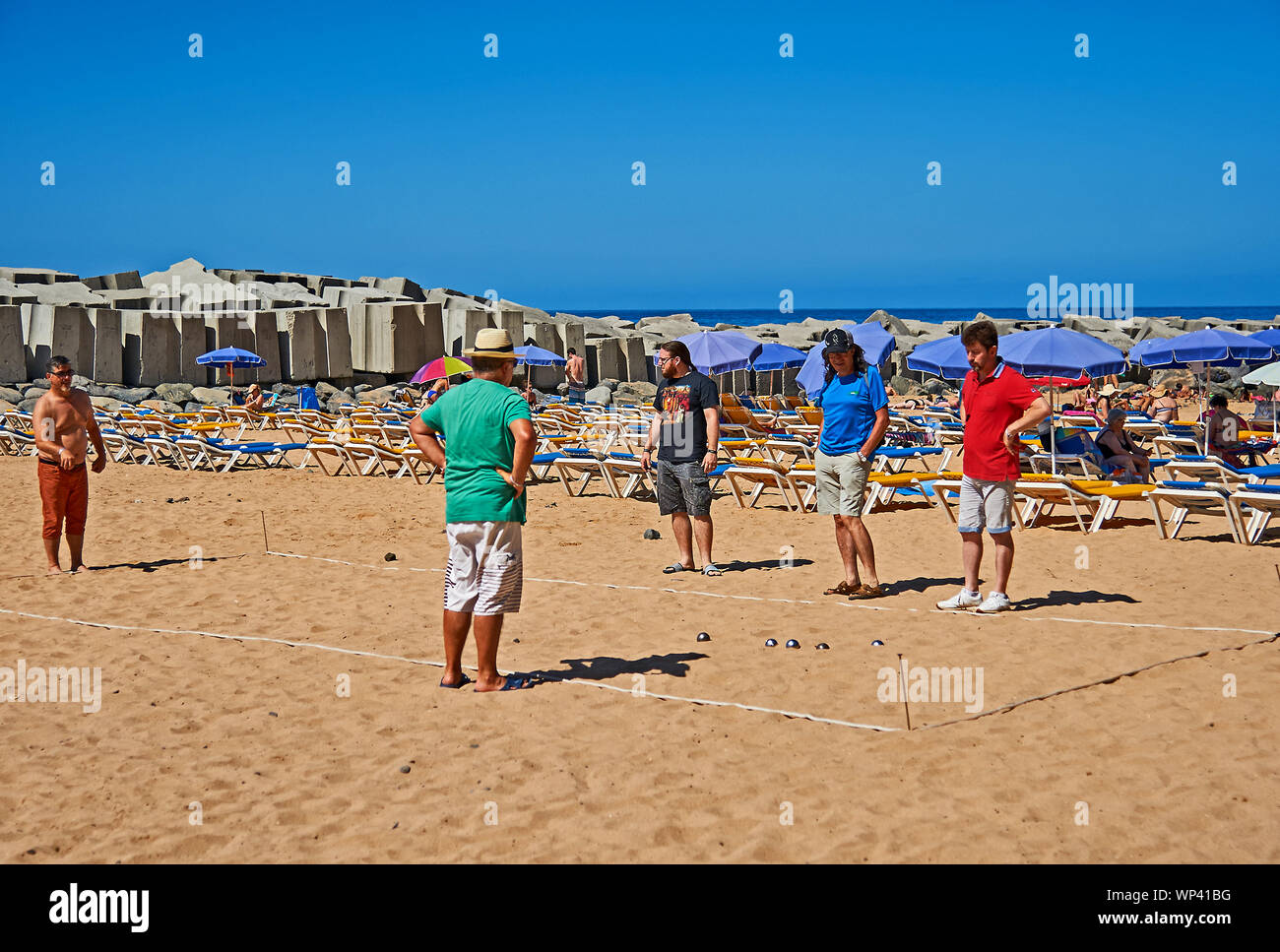 Calheta, Madeira and a group of locals playing boules on the beach ...