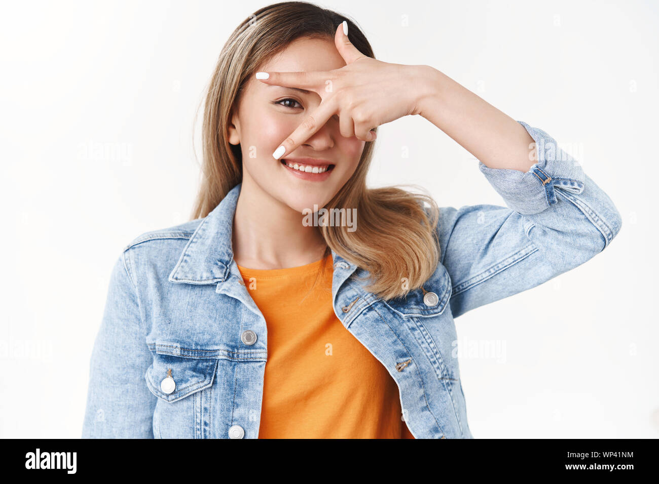 Silly optimistic lucky asian blond girl show peace victory gesture fool ...