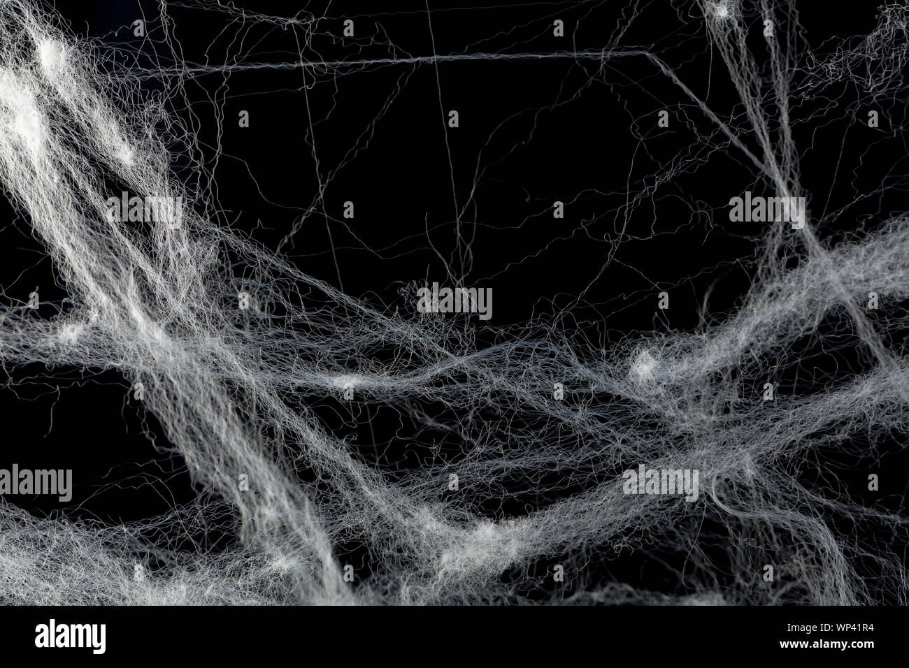 Cobweb or spider's web against a black background, to be used as ...