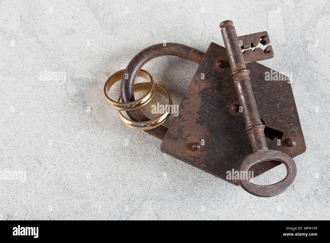 Two wedding rings in a rusty old lock Stock Photo - Alamy
