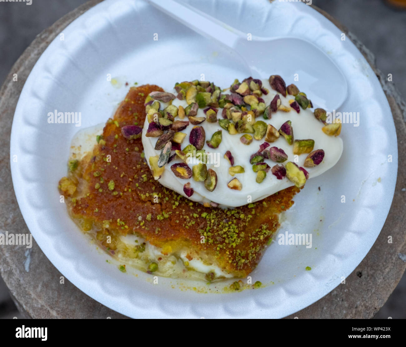 Arabic dessert Kunafa made with cheese and honey and pistache with ice ...
